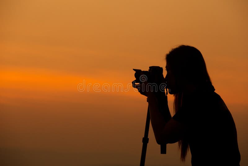 Silhouette of Woman Shooting with Camera at Sunset Stock Photo - Image ...