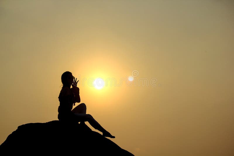 Silhouette of a Woman Sitting on a Rock Stock Photo - Image of balance ...