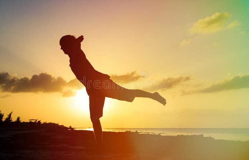 Silhouette of Young Man Doing Yoga at Sunset Stock Photo - Image of ...