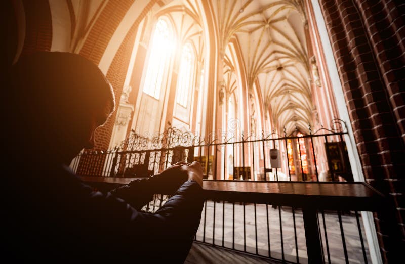 Silhouette of Young Man Praying in Church in Sunlight Stock Image ...