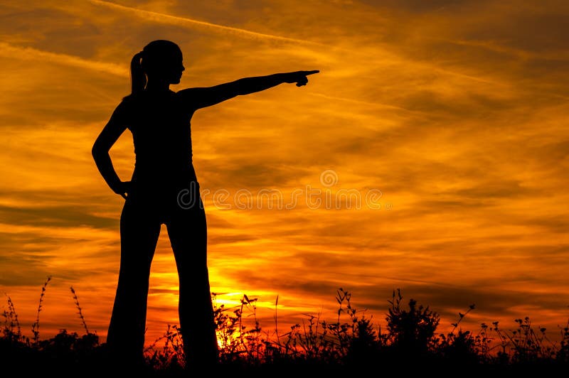 Silhouette of the Young Woman Pointing To Something in the Distance ...