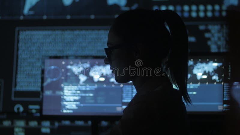 Silhouette of Young Woman it Programmer Working at a Computer in the ...