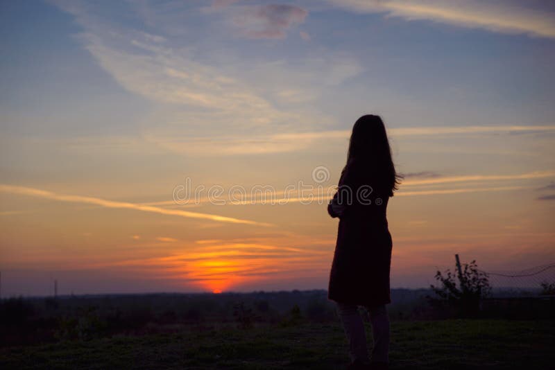 Silhouette of a Young Woman Standing on Sunset Stock Image - Image of ...