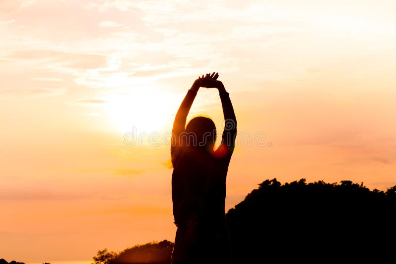 Silhouette of Young Woman Standing at Relax Pose or Freedom Pose or ...