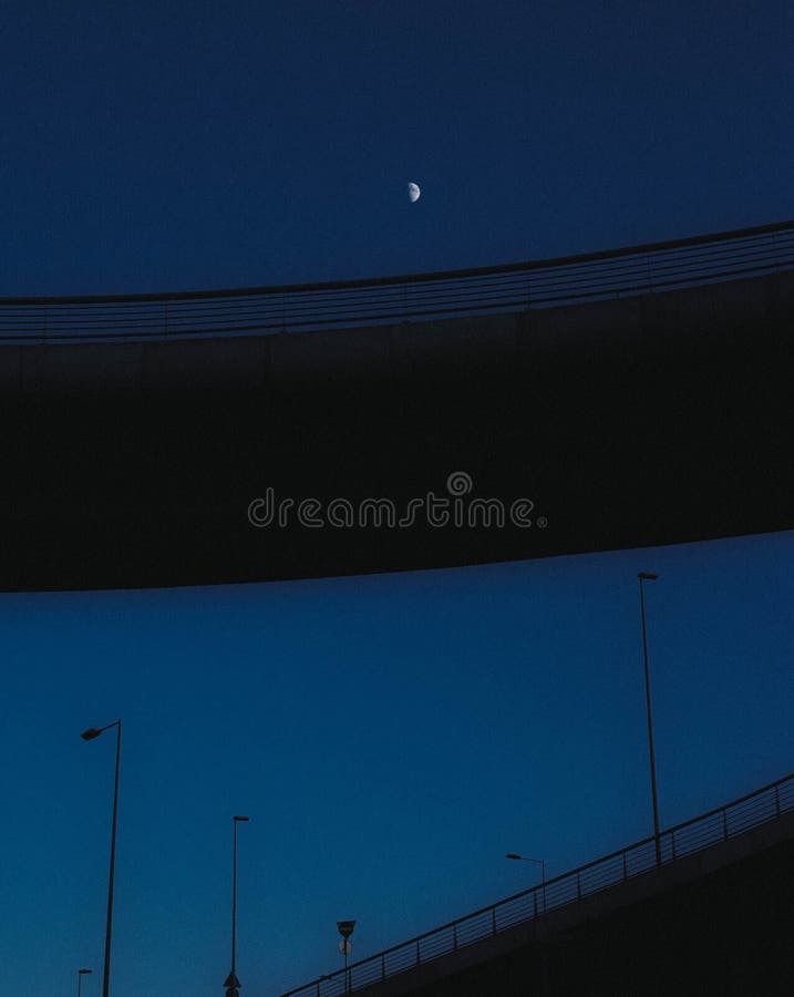 Silhouetted Bridge Against a Backdrop of an Evening Sky with a Crescent ...