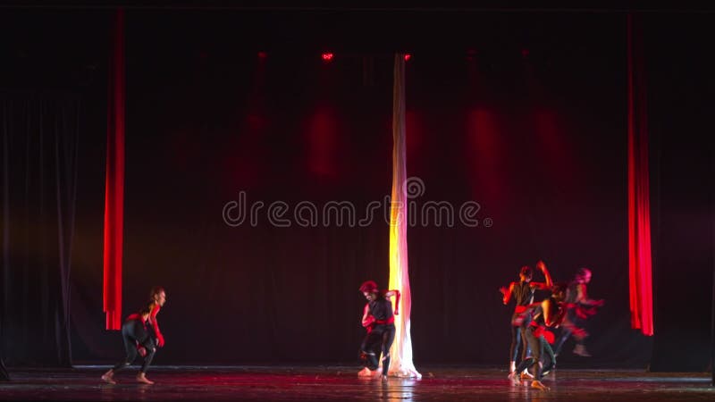 Silhouetted Dancers on Stage with Dramatic Lighting and a Dark ...