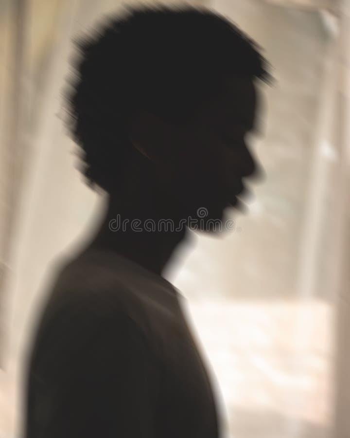 Silhouetted Human Figure Standing in Profile Next To a Wall, Light from ...