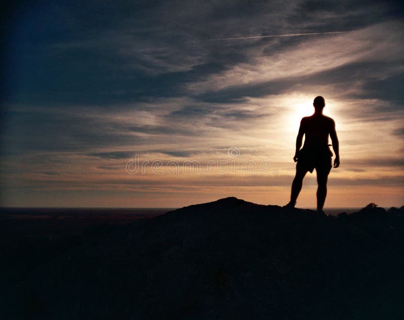 Silhouetted Man stock photo. Image of sunset, cloud, color - 9431626