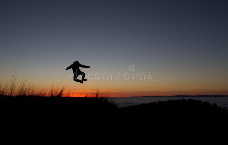 Silhouetted of Man Jumping in Sunset Stock Image - Image of people ...