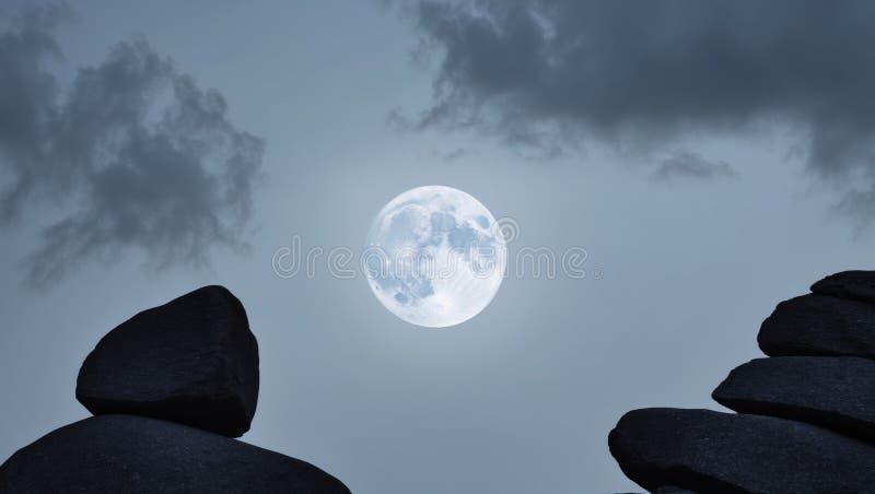 Silhouetted Rock Formations with a Glowing Moon in a Cloudy Sky. Stock ...
