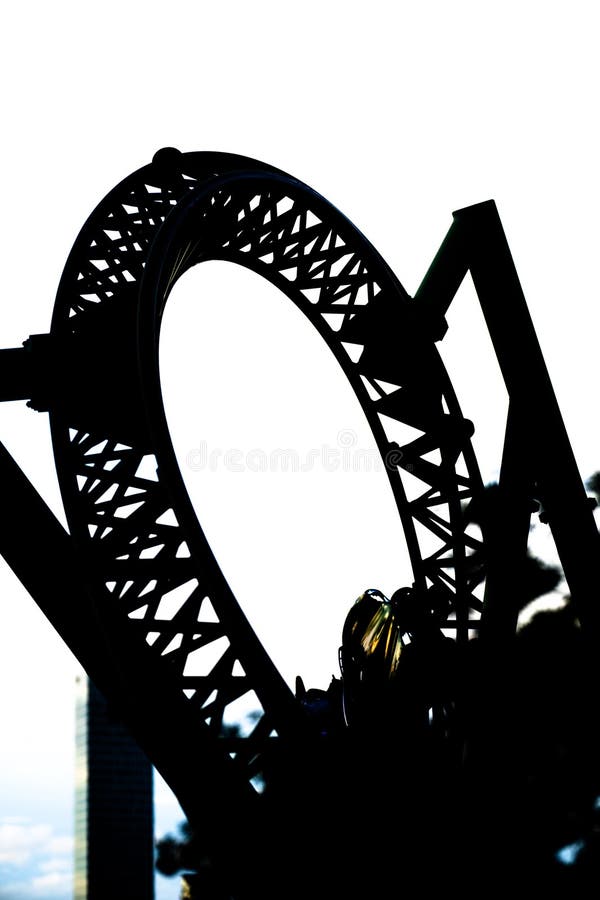 Silhouetted Roller Coaster Loop with Riders Against Bright Sky.. Stock ...