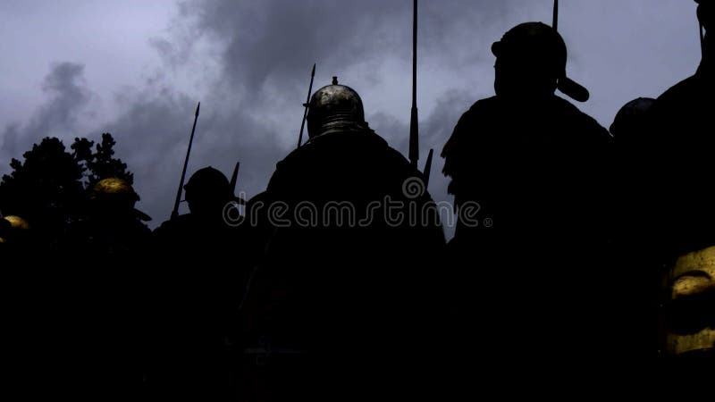 Silhouetted Warriors with Spears Under Twilight Sky, Evoking Ancient ...