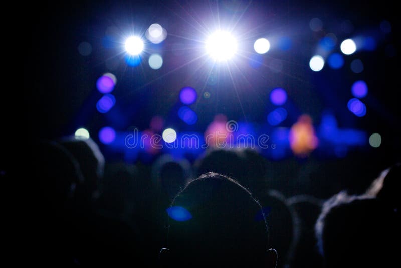Silhouettes Of Concert Fans In Front Of Bright Scene Lights Stock Photo ...