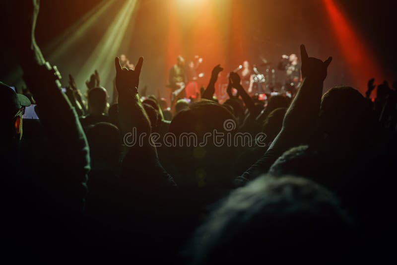 Silhouettes of Enthusiastic Fans with Raised Hands are Illuminated by ...