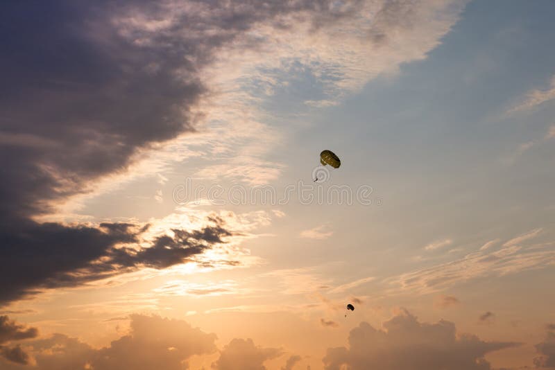 Silhouettes of Flying Parachutes on the Sunset Sky Stock Image - Image ...