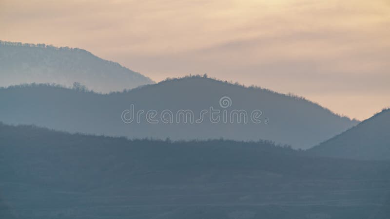 Silhouettes of Mountains in the Sunset Haze Stock Photo - Image of haze ...