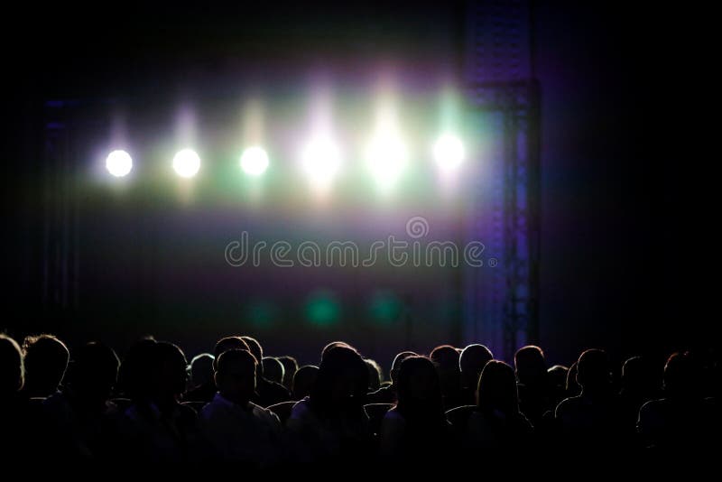 Silhouettes of People Under Bright Background Lights Stock Photo ...