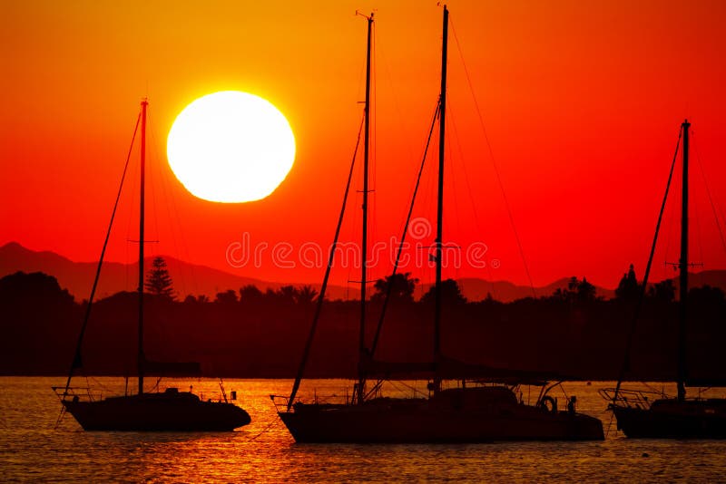 Silhouettes of Sailing Boats at Red and Orange Sunset Stock Photo ...