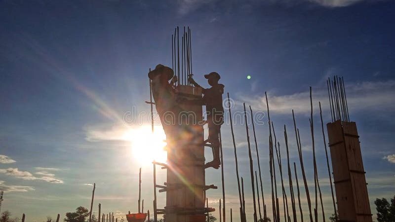 Silhouettes of Workers on a Construction Site, during the Hot Sun ...