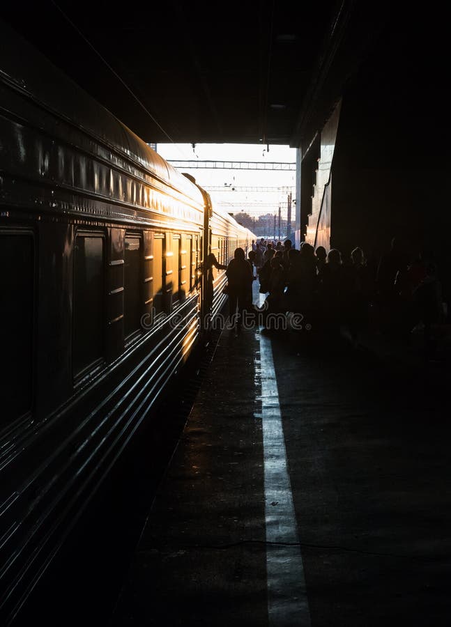 Silhuettes of People Walking into the Train - Bright Sunset Stock Image ...