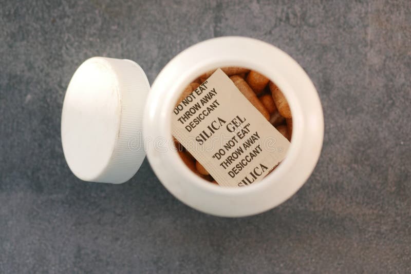 Silica Gel Container with Warning Label on a Gray Surface Stock Photo ...