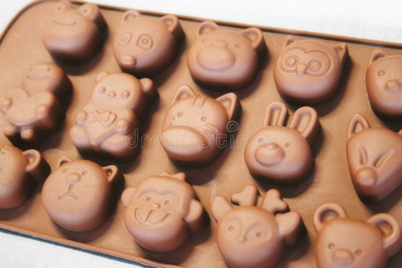 A Silicon Mold for Making Chocolate Shapes with Animals Against a White ...