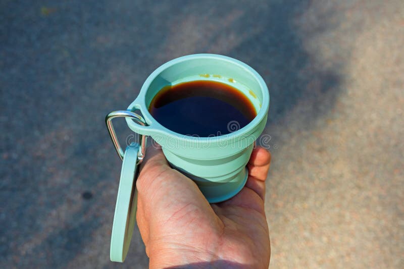 Silicone Reusable Folding Cup with Lid in Hand. Coffee To Go in a ...