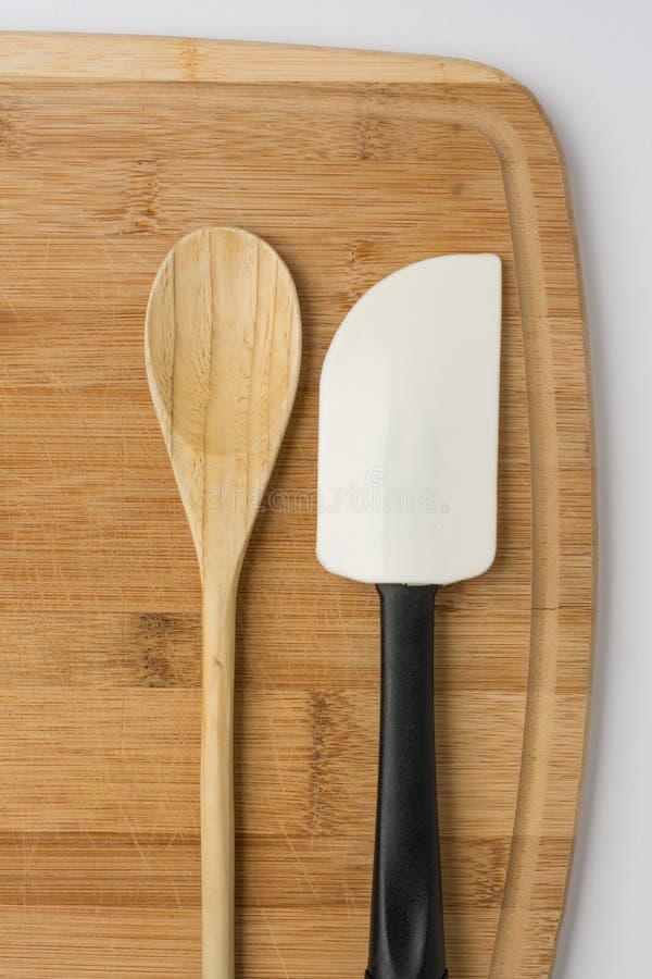 Silicone Spatula and Wooden Spoon on Wooden Cutting Board Stock Image ...