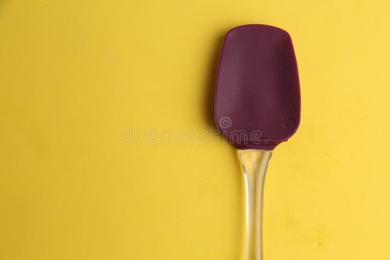 Silicone Spatula on a Yellow Surface Stock Image - Image of hold ...