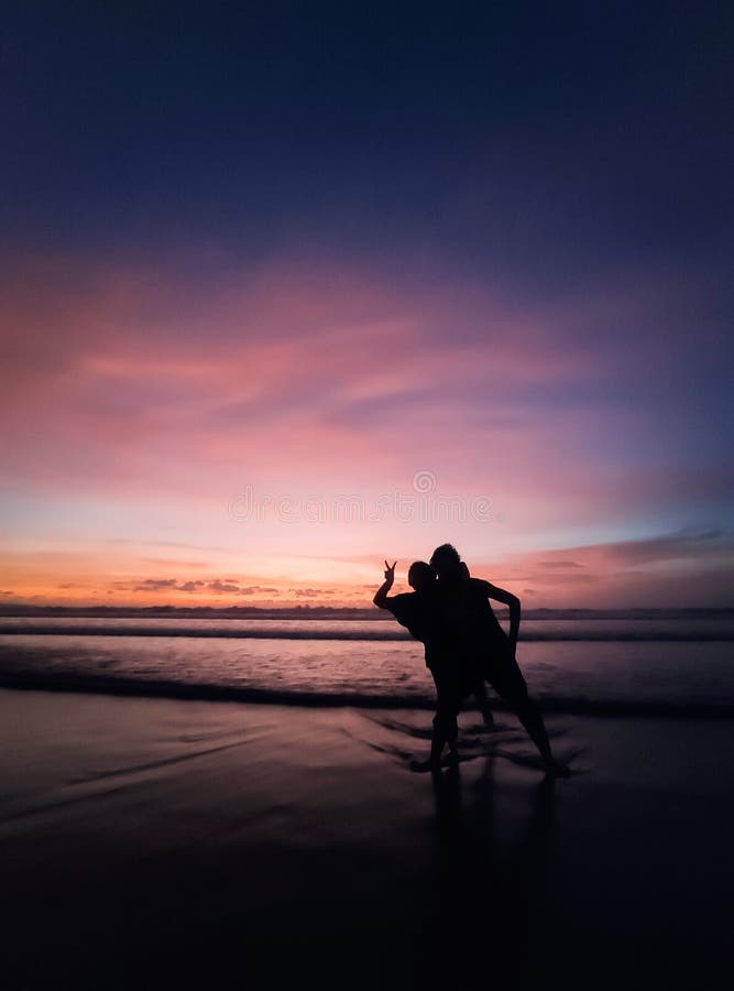 Silouette of Beachgoers Watching the Sunset with a Very Beautiful Sky ...