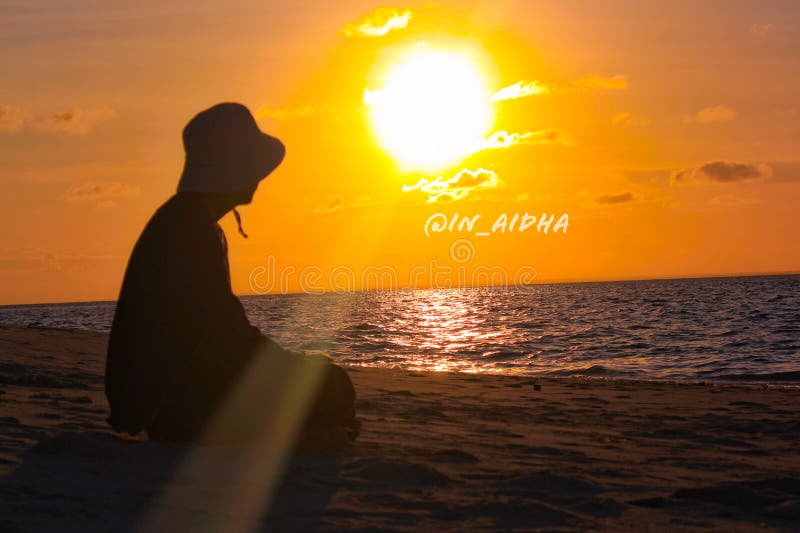 Siluet on sunset beach stock photo. Image of siluet - 209640996