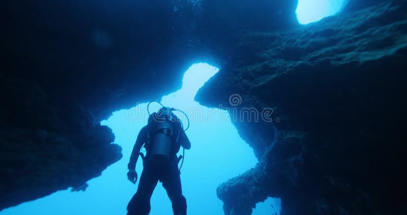 Silueta De Un Buceador Scuba Nadando En Una Cueva Submarina. Un ... Silueta De Un Buceador Scuba Nadando En Una Cueva Submarina. Un ...