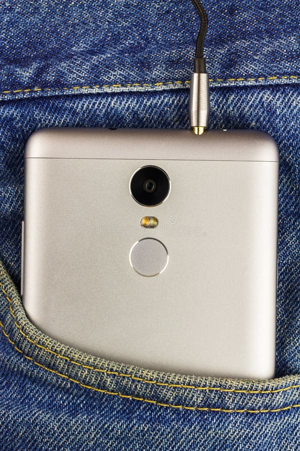Silver Aluminum Smartphone with Headphone Cable in Pocket of Blue Jeans ...