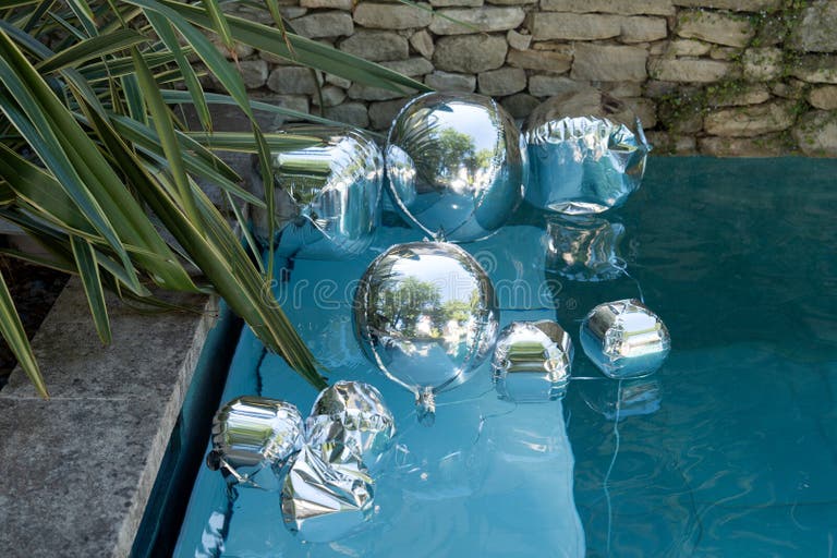 Silver Balloons Float in Pools As Birthday Party Decorations Stock ...