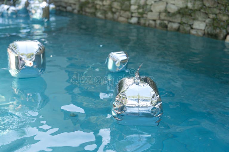 Silver Balloons Float in Pools As Birthday Party Decorations Stock ...