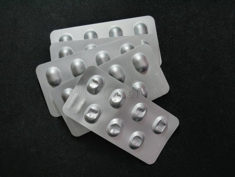 Silver Blister Packs of Treatment Pills on Black Background Stock Image ...