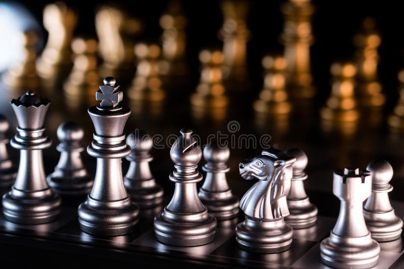 Silver Chess Pieces with Golden Figures in Background Stock Photo ...