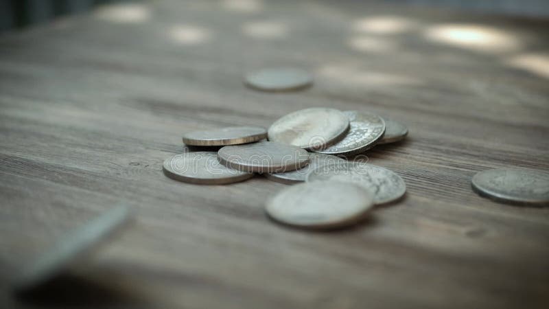 American Silver Coins Falling in Slow Motion Onto a Wooden, Rotating As ...