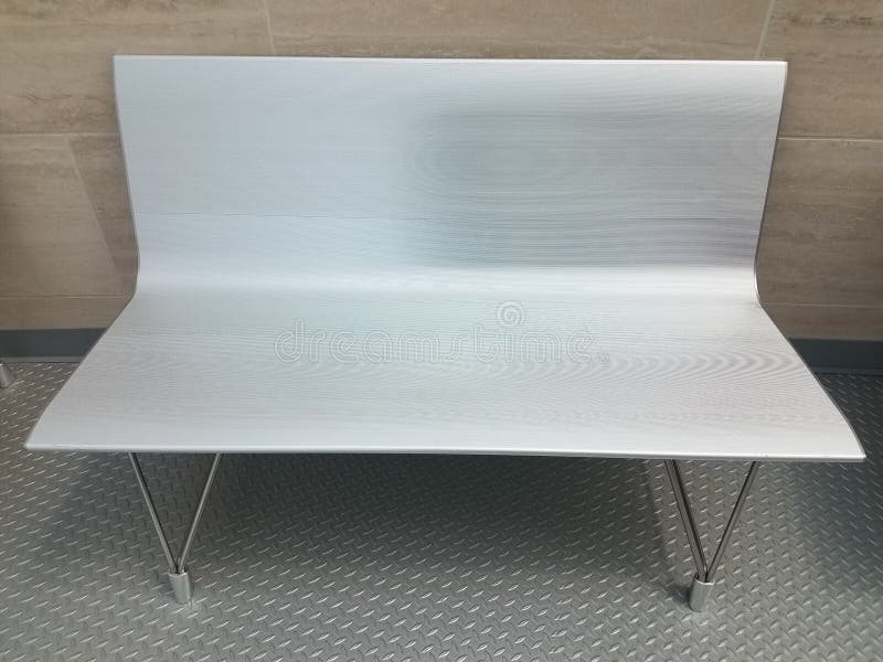 Silver Colored Metal Bench Near Wall Stock Photo - Image of chair ...