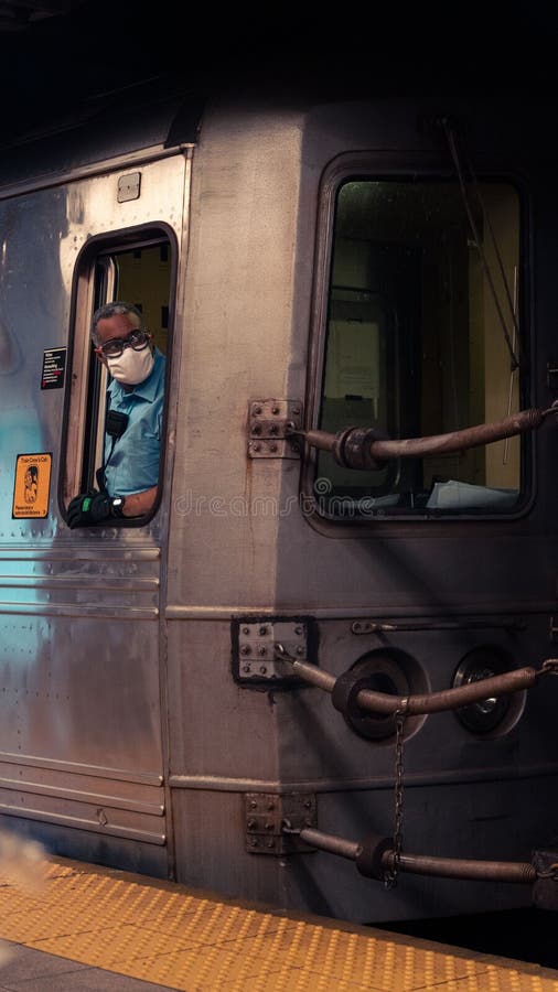 Silver-colored Train Idling at a Railway Station, Awaiting Passengers ...