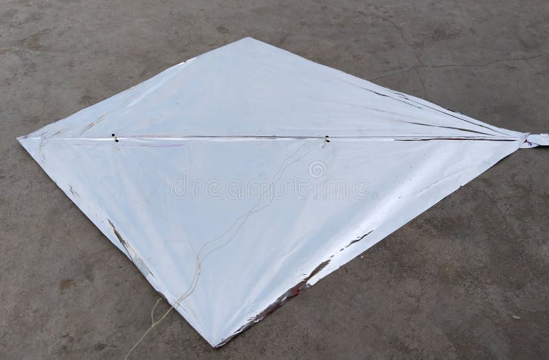 Silver Colour Plastic Kite Placed on a Concrete Floor Stock Image ...