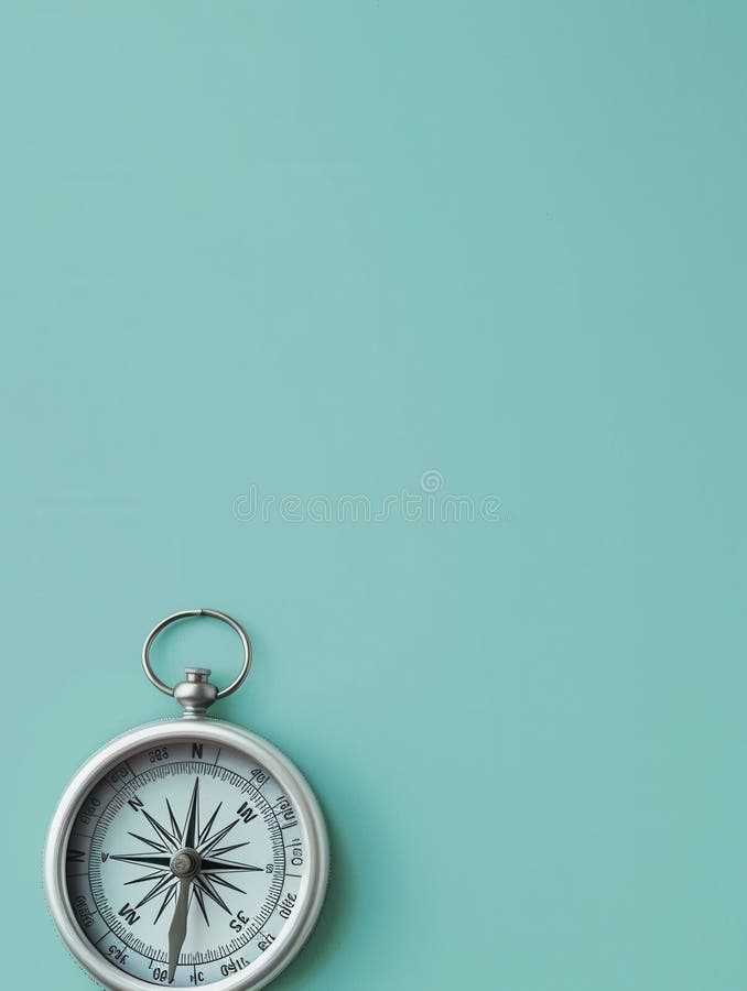 A Silver Compass Sits on a Mint Green Background. the Compass Features ...