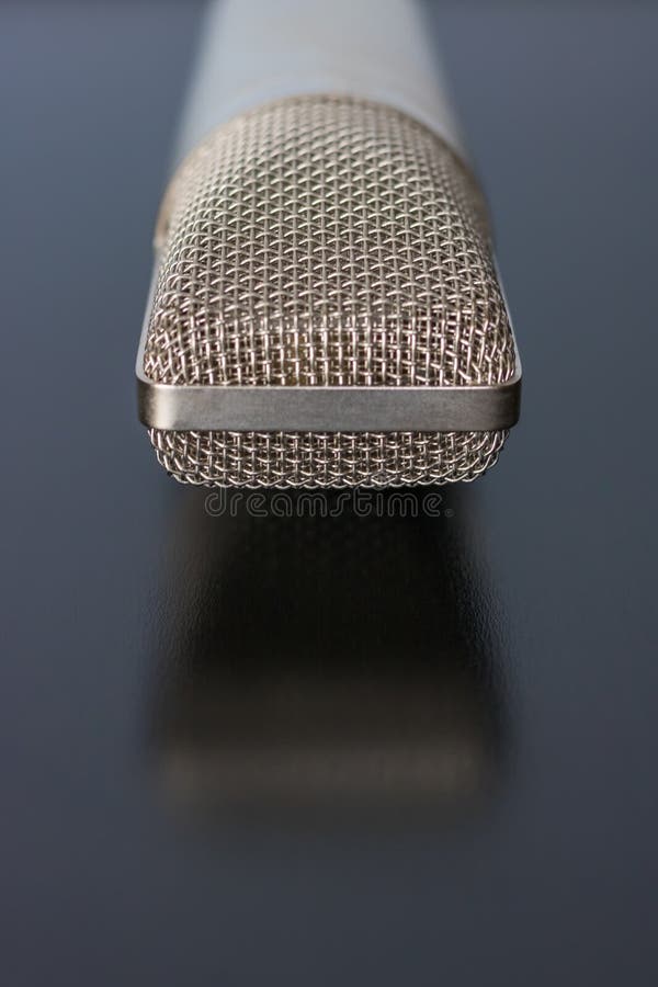 A Microphone Reflecting Off a Shiny Surface Stock Image - Image of ...