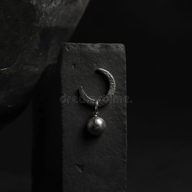 Elegant Silver Crescent Pendant on Textured Black Stone Background ...