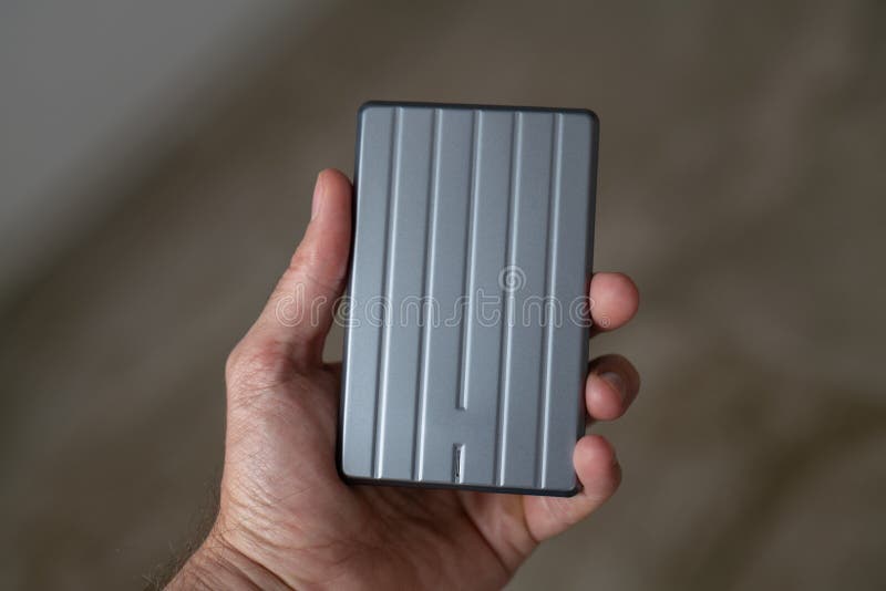 Silver External Hard Drive in Mans Hand. External HD Stock Photo ...