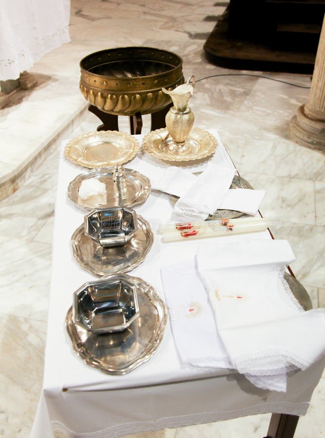 Religious Silver and Gold Items Displayed on a Table with a White ...