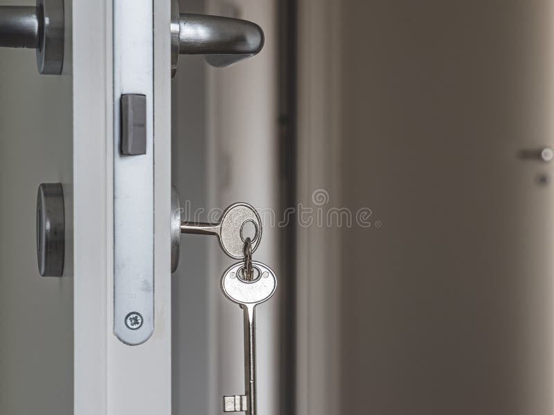 A Silver Key Inside the Door Lock. Stock Photo - Image of home ...