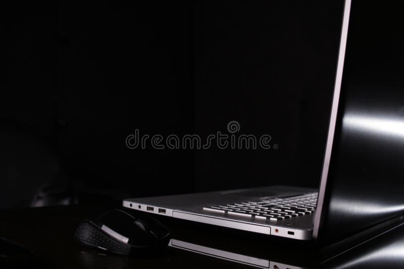 Silver Laptop in the Dark stock photo. Image of desk - 152624628