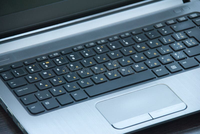 Silver Laptop Keyboard and a Touchpad. Laptop on a Wooden Table Stock ...