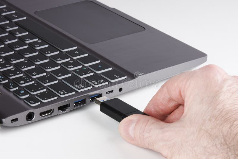 Silver Laptop and Male Hand Holding USB Flash Disk and Plugging Stock ...